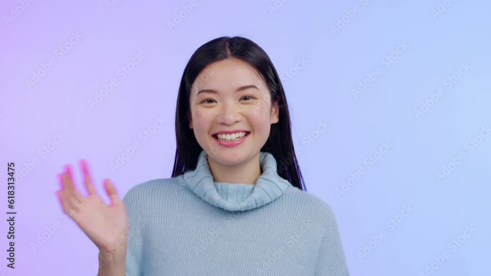Video call, portrait of asian woman wave hand and against a studio ...