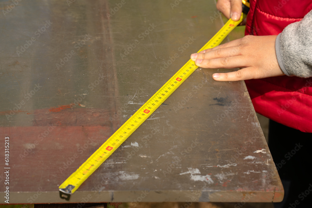 Measure the distance with a tape measure.The child learns to take ...