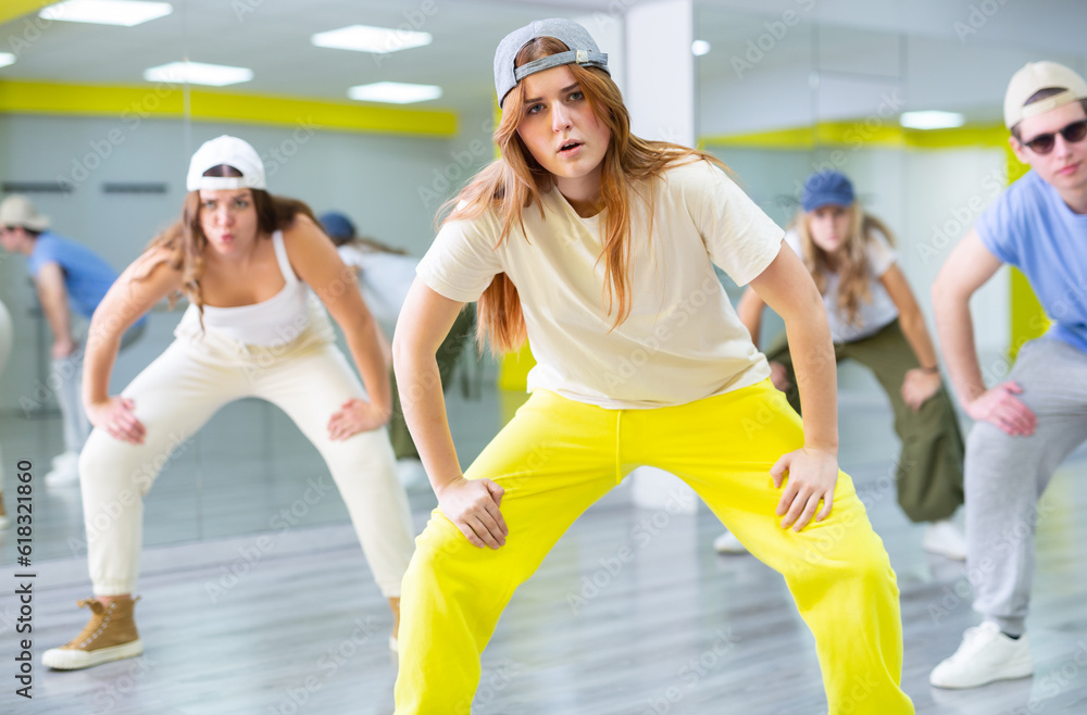 Teenager girl in cap dances hip hop dances in dance studio Stock Photo ...