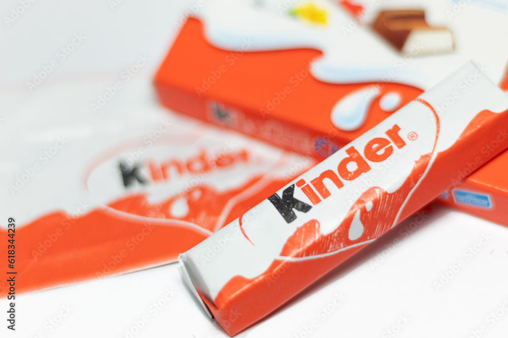 A packaged Kinder chocolate bar next to a packaging and a box of the ...