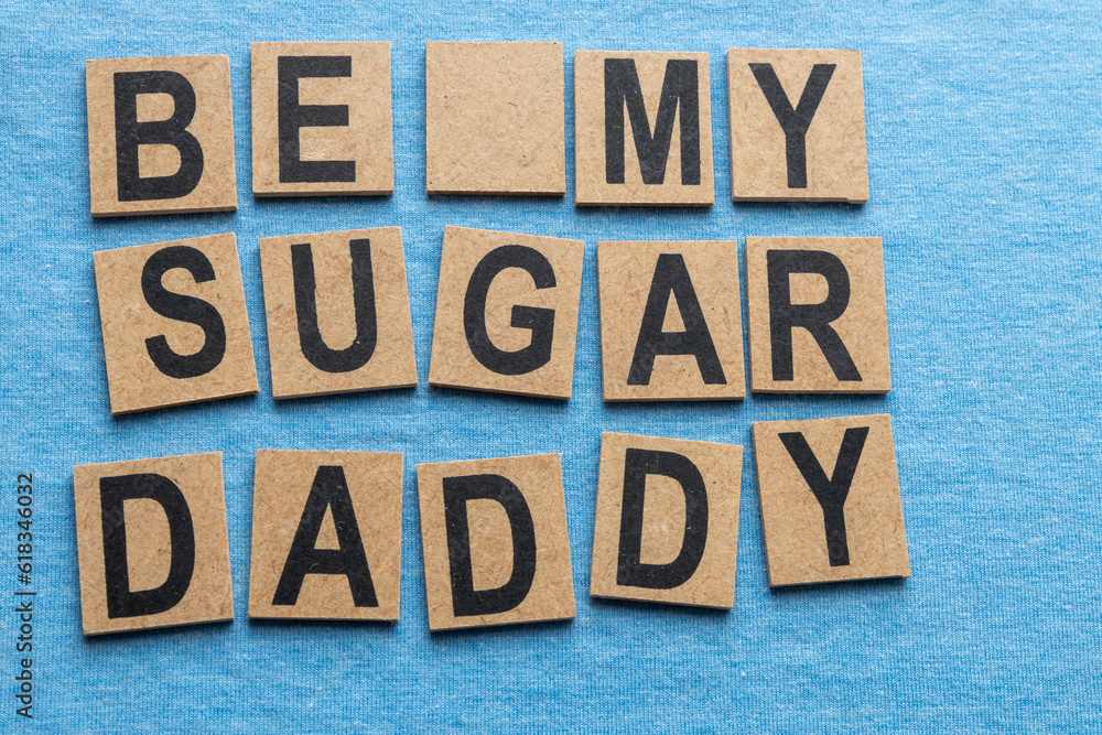 Sign formed with small pieces of wood with the text "be my sugar daddy ...