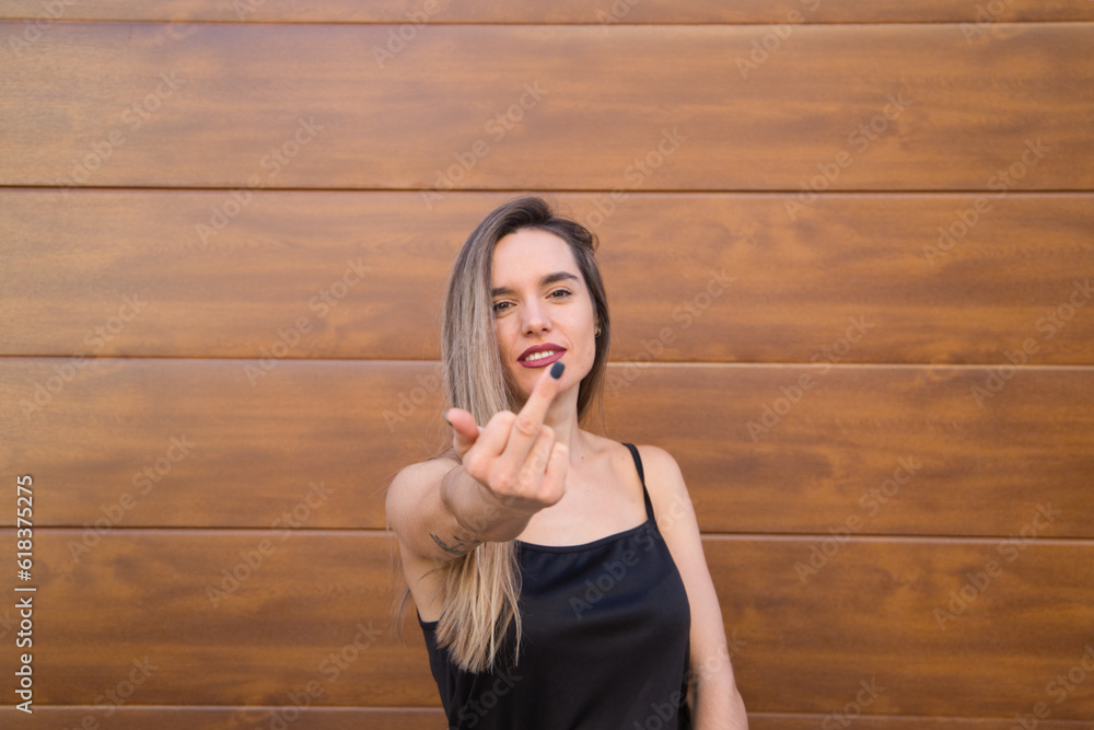 Young attractive woman raises hand showing negative emotions and forms ...