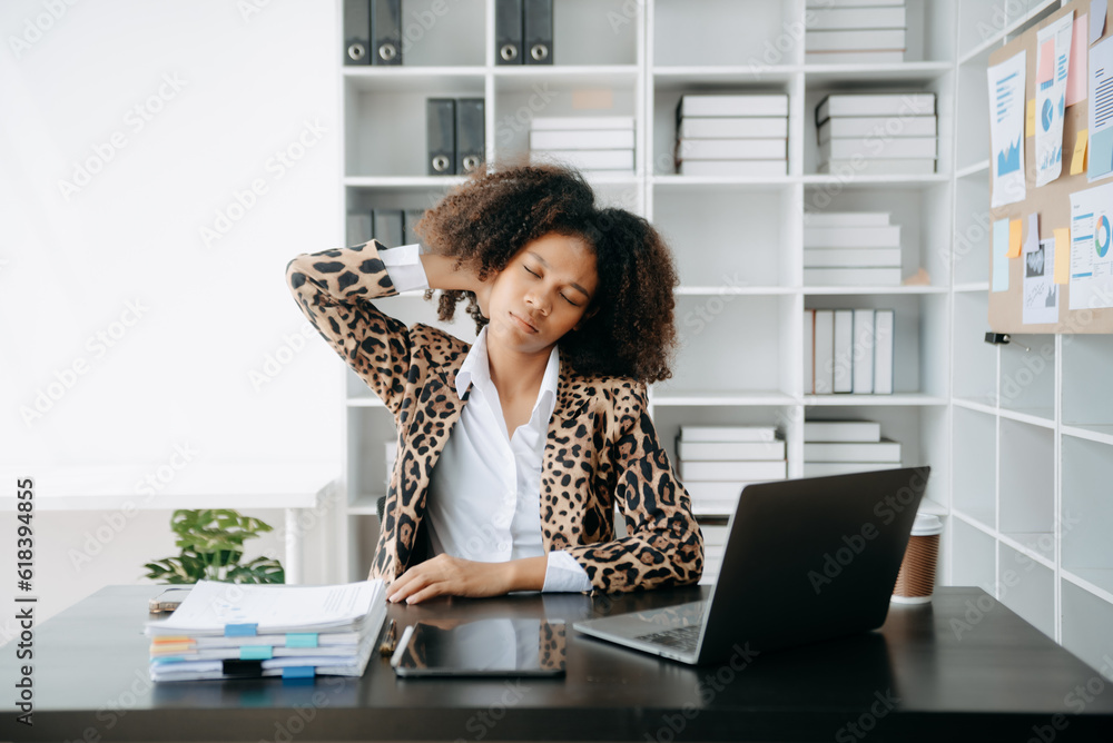 Overworked young African businesswoman office worker suffering from ...