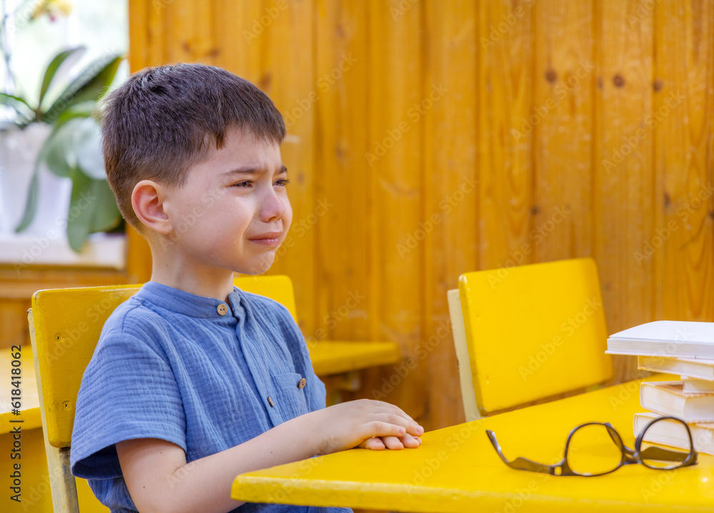 cute preschooler boy crying in classroom or outside with backpack in ...