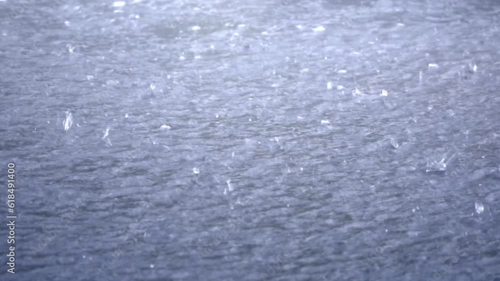 torrential rain in summertime with raindrops on flooded road in ...