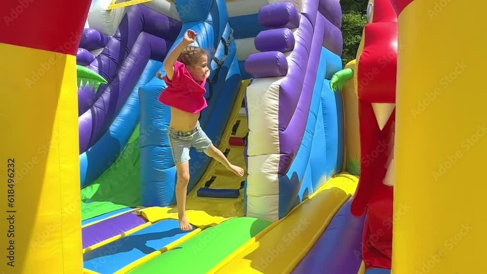 Child jumping on colorful playground trampoline. Kids jump in ...