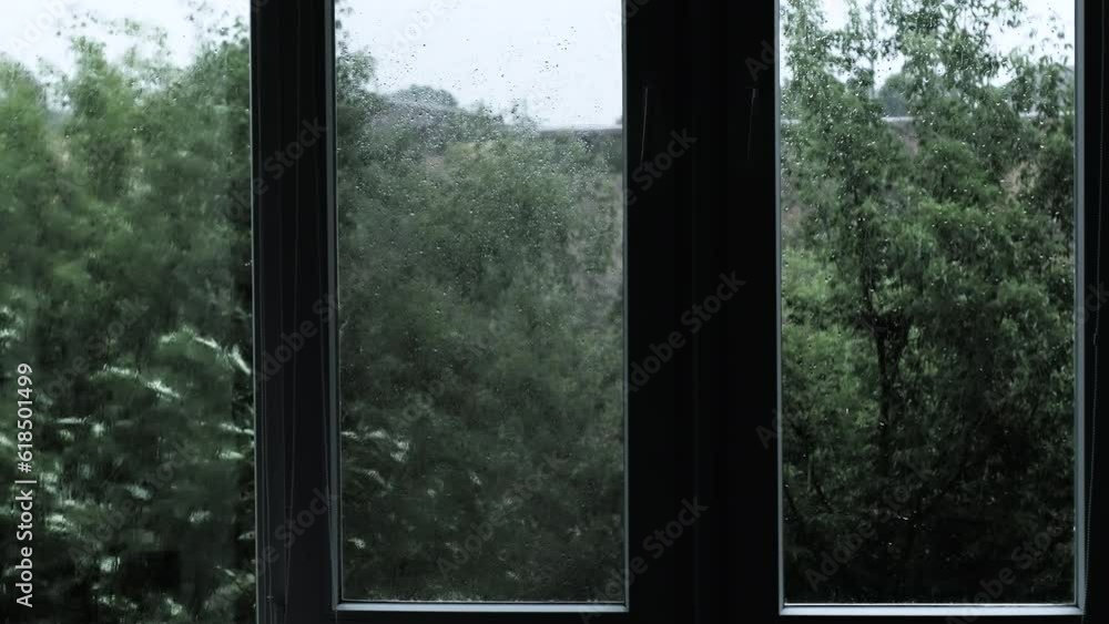 Rain outside the window with a strong wind. Drops are not glass ...