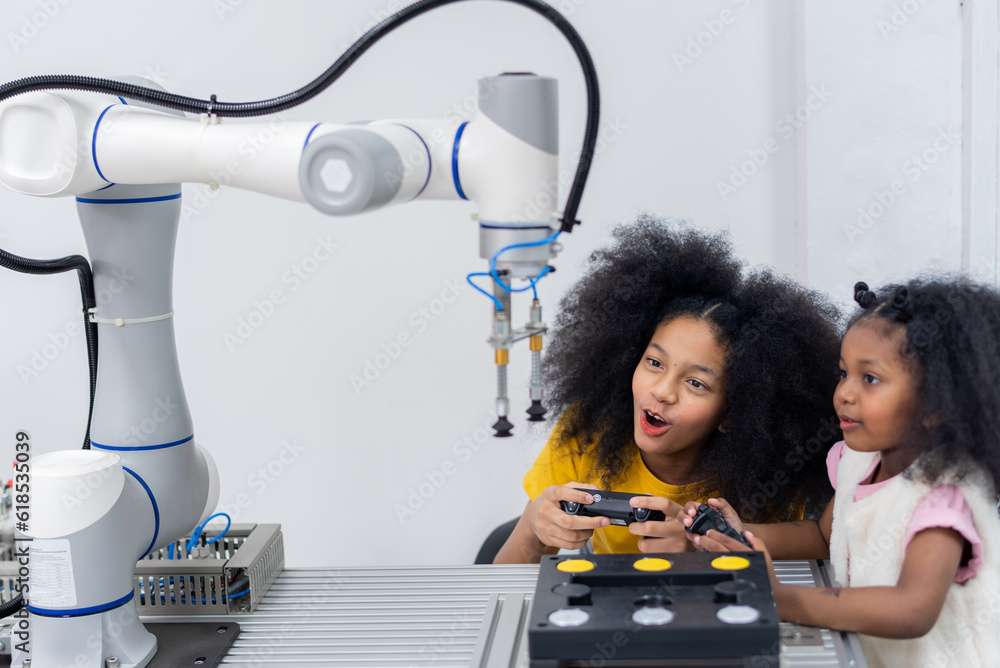 Kid female teen child enjoy Machine Learning Robot arm is Moving Under ...