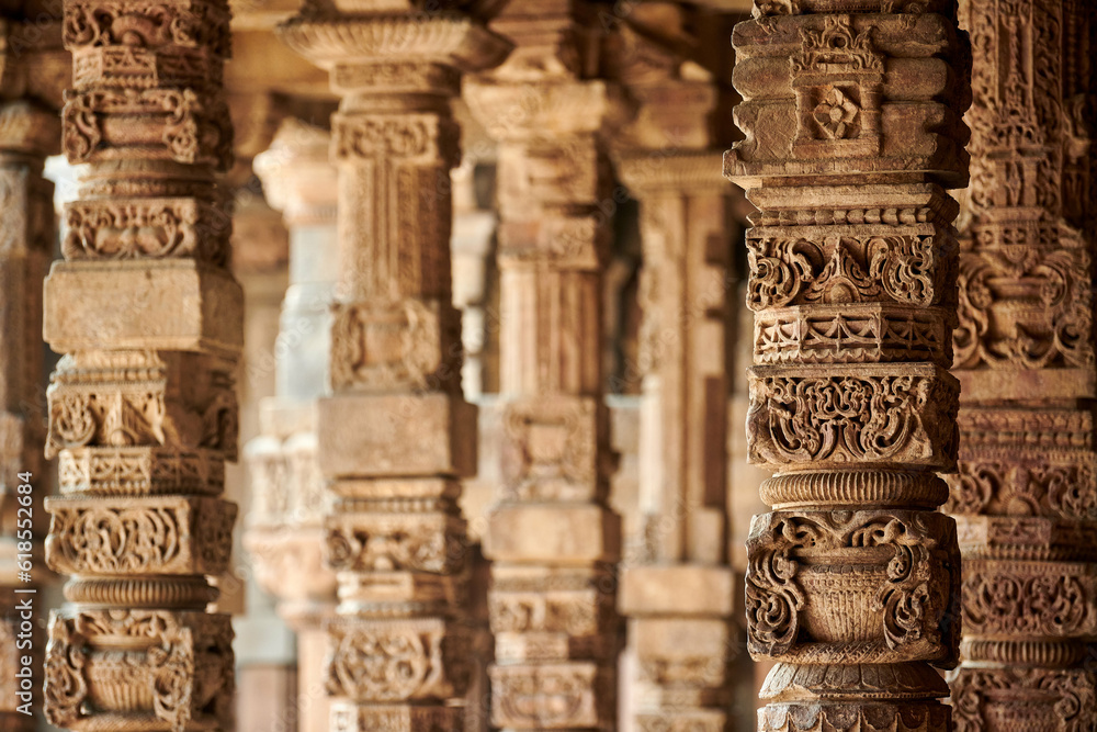 Stone columns with decorative bas relief of Qutb complex in South Delhi ...