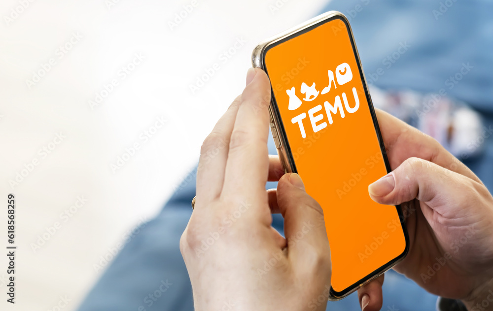 Hands holding a phone with Temu logo displayed on the screen Stock ...