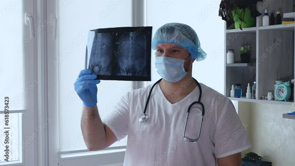 Calculus 8 mm in the ureter on x-ray in the doctor's hands. Doctor ...