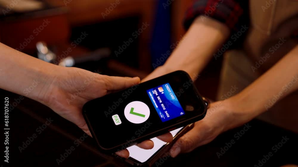 Cafe bakery worker stands on phone with QR code for payment account ...