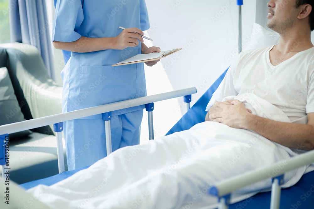 Patient on an inpatient hospital bed with a doctor examining and asking ...