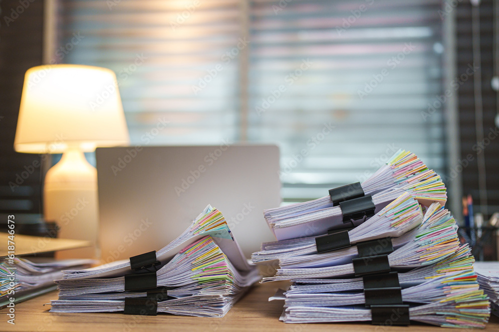 Piles of white papers Stacks of office working paper documents files with black clip on the desk ...