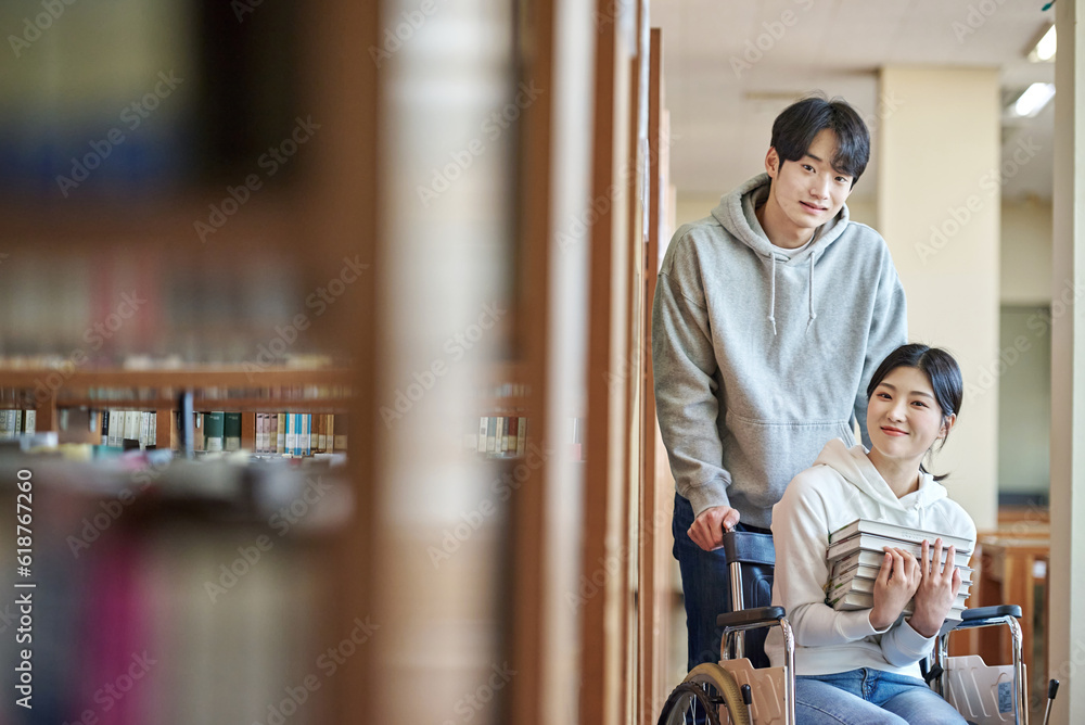 Young handicapped female college student model with disability sitting ...