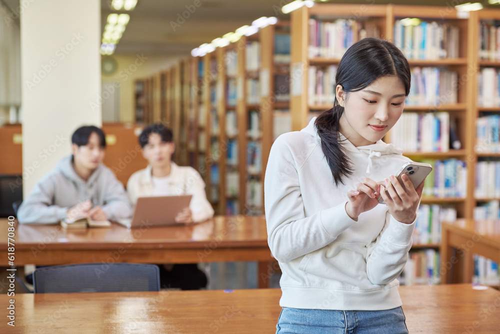 Young Asian Korean female model, male model and bookshelf background ...