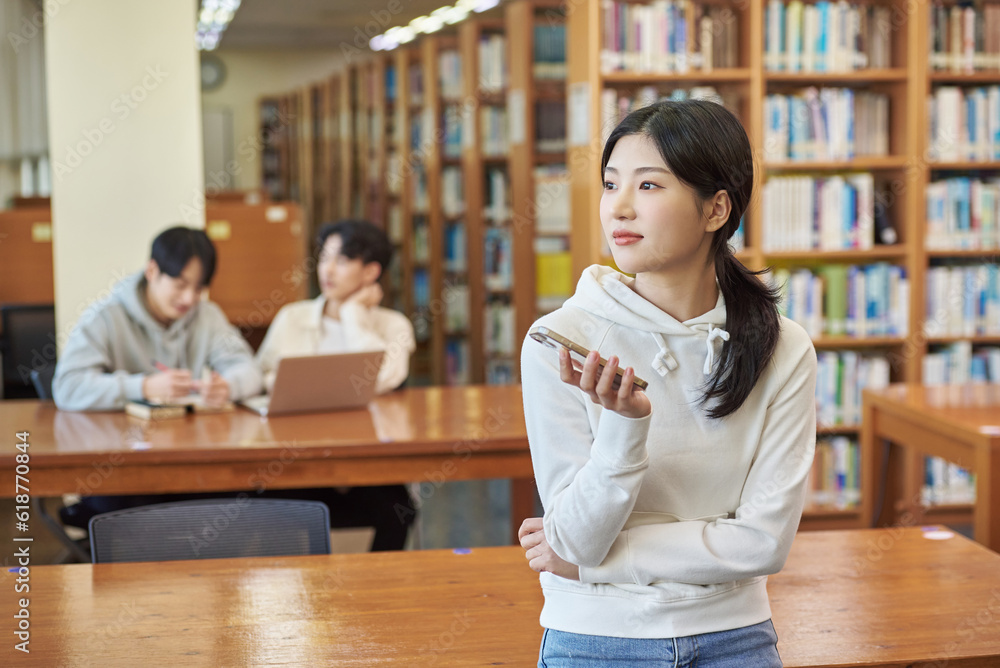 Young Asian Korean female model, male model and bookshelf background ...