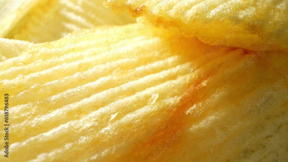 Macro video captures the texture of wavy potato chips with a ...