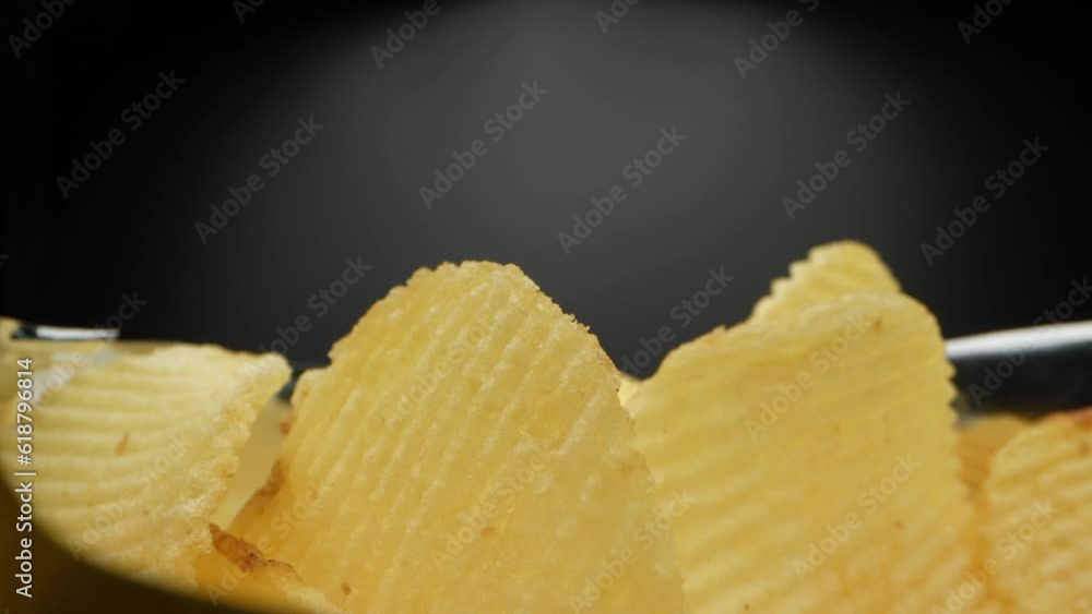 A macro video captures the intricate ridges and curves of wavy potato ...