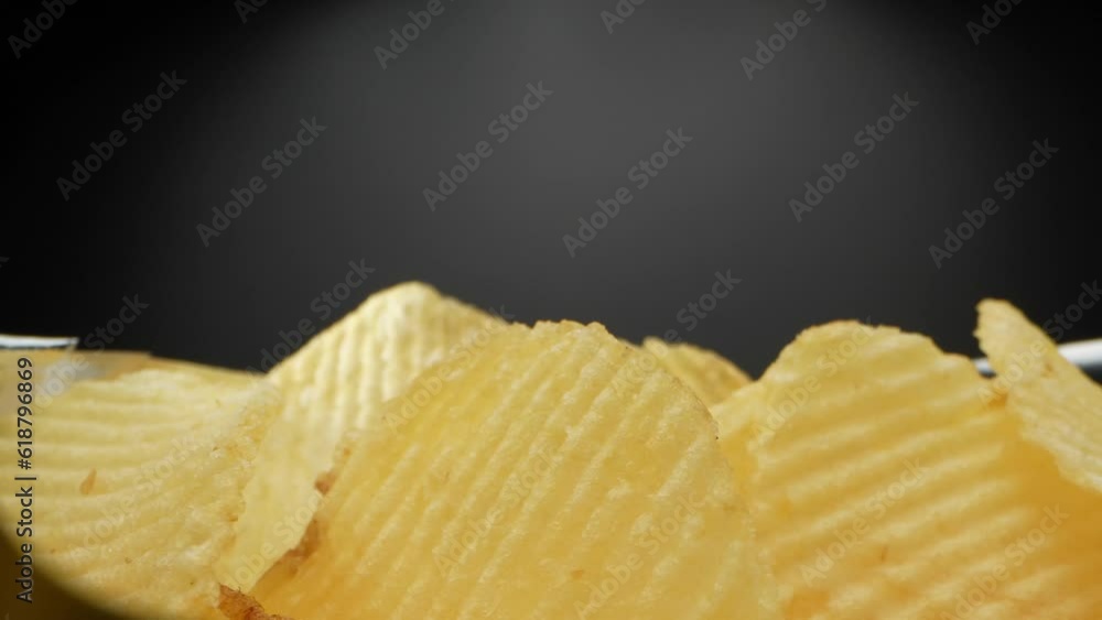 A macro video captures the intricate ridges and curves of wavy potato ...