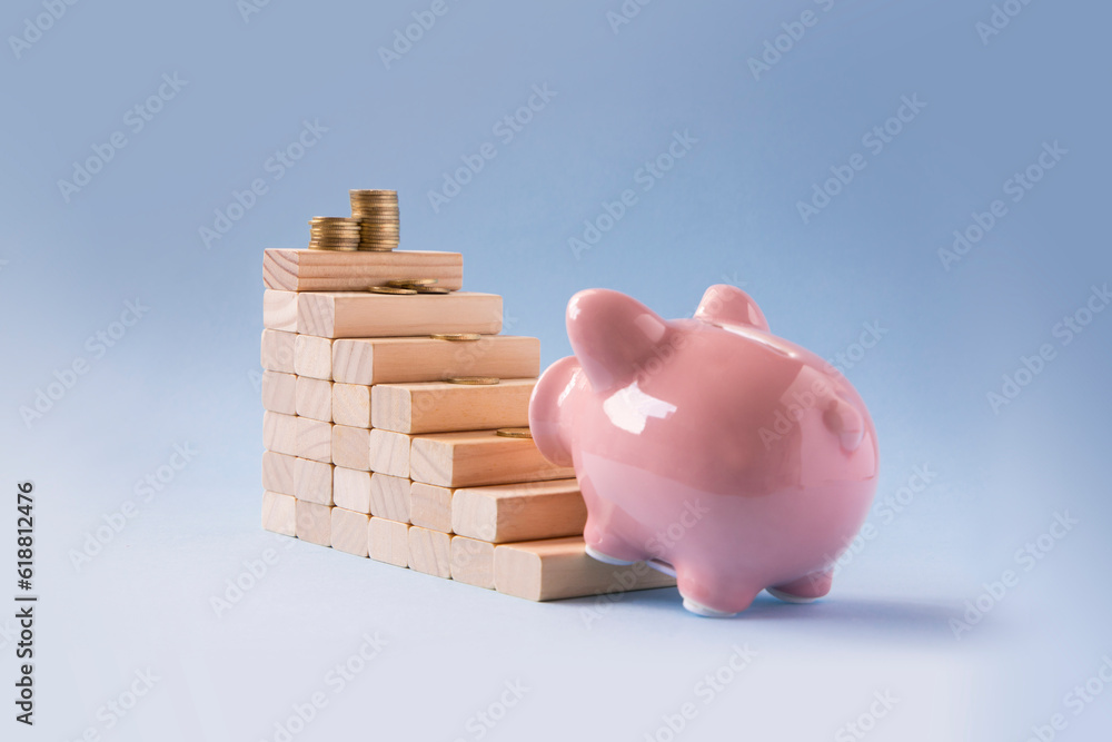 Piggy bank moving up steps to a stack on coins still life. Financial ...