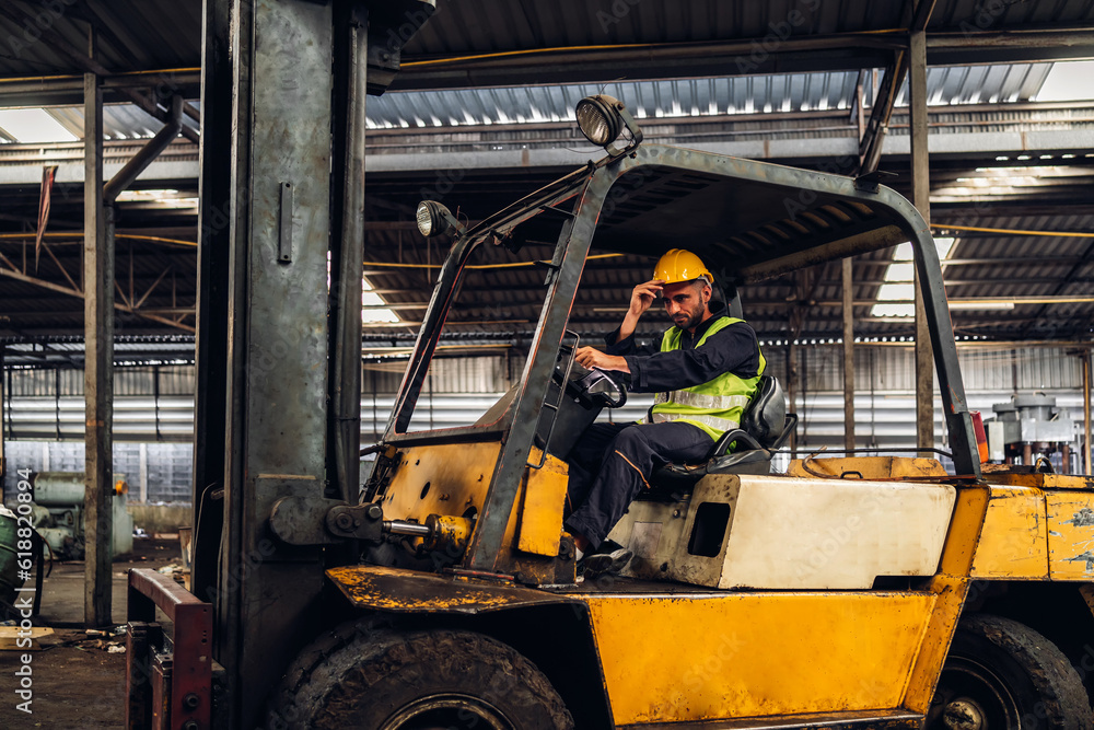 Man worker at forklift driver happy working in industry factory ...
