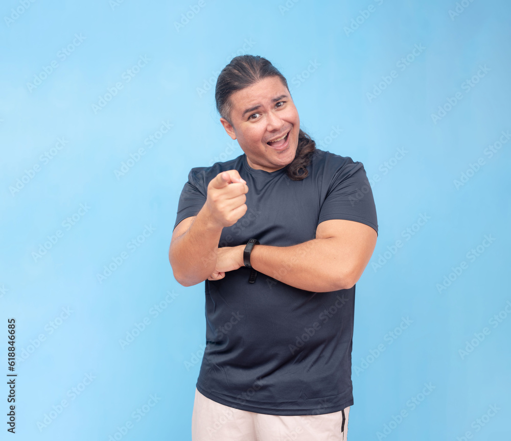 A skeptical and amused biracial male chuckling while pointing forwards ...