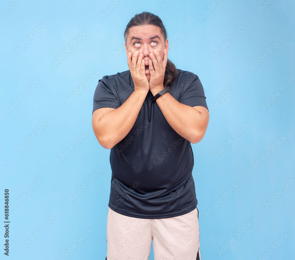 A disappointed and desperate biracial male pulling his face down with ...