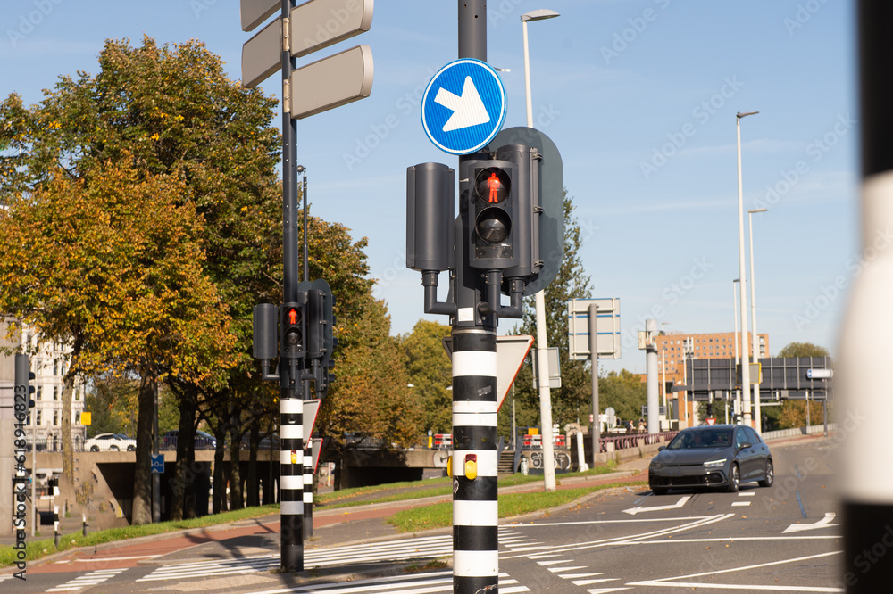 Traffic light-regulated intersection with road signs. Red traffic light ...