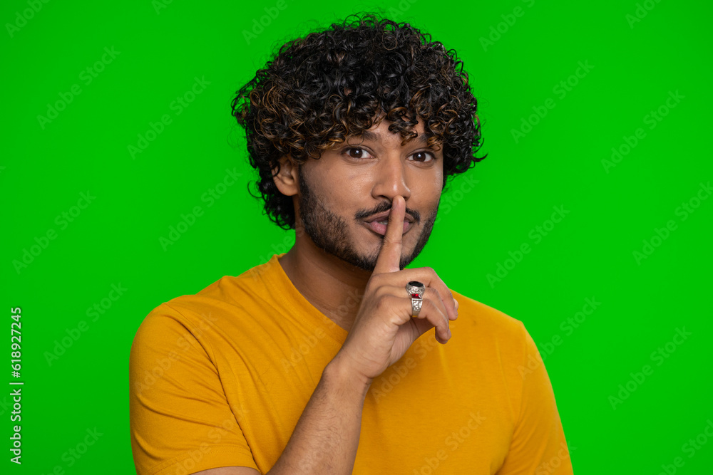 Shh be quiet please. Young indian man presses index finger to lips ...