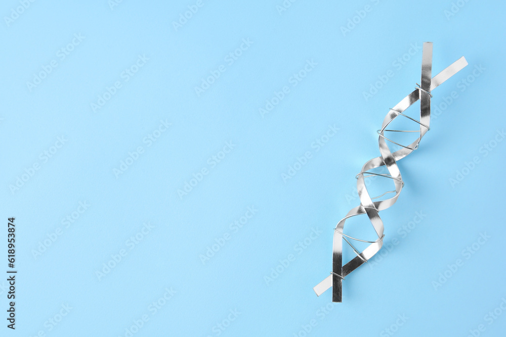 DNA molecular chain model made of metal on light blue background, top ...