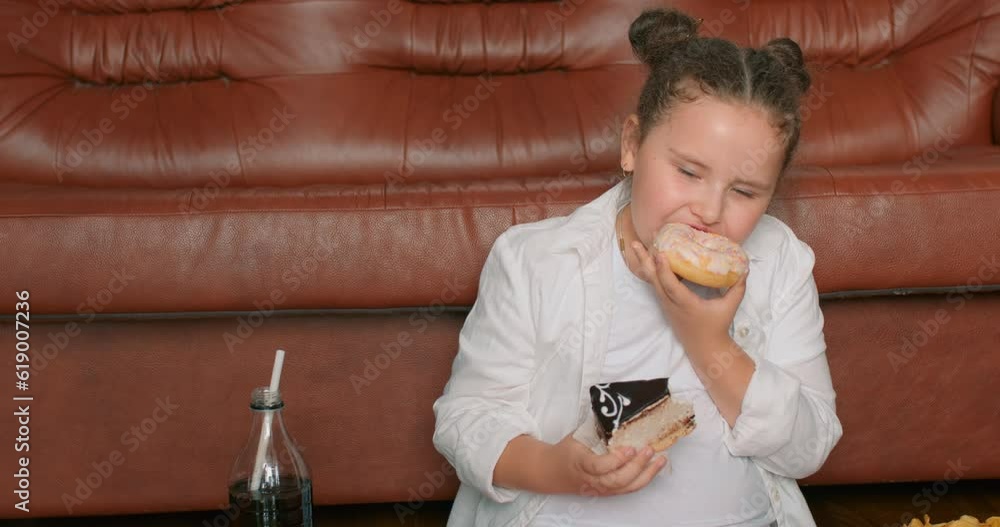 fat hungry little girl biting piece of cake, eating donut Sweet tooth ...