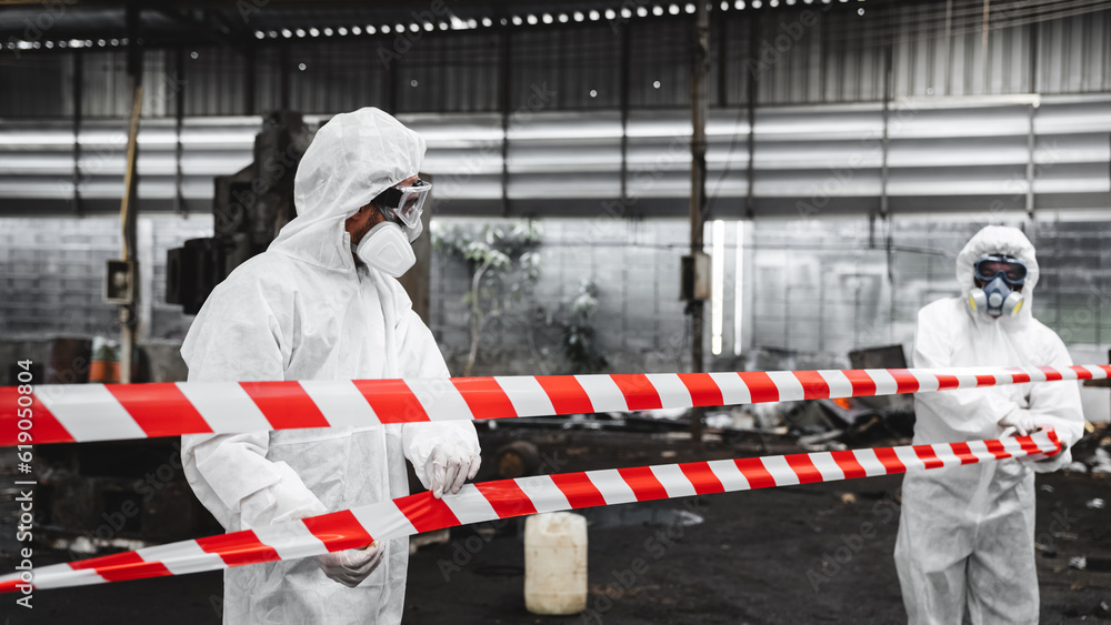 Workers wear protection suit checking chemical contaminated oil in old ...