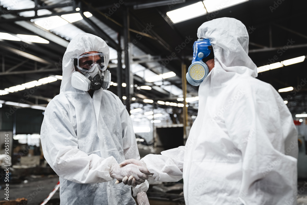 Scientist workers wear protective suit shack hand with team when ...