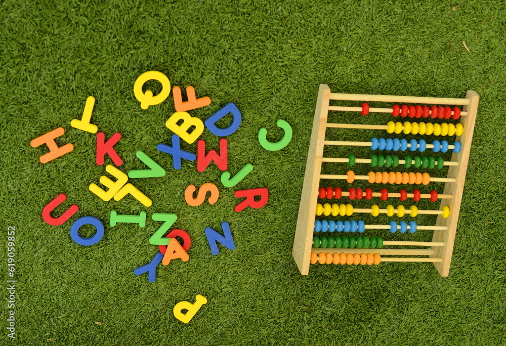 Multi-colored wooden abacus and letters of the English alphabet on a ...