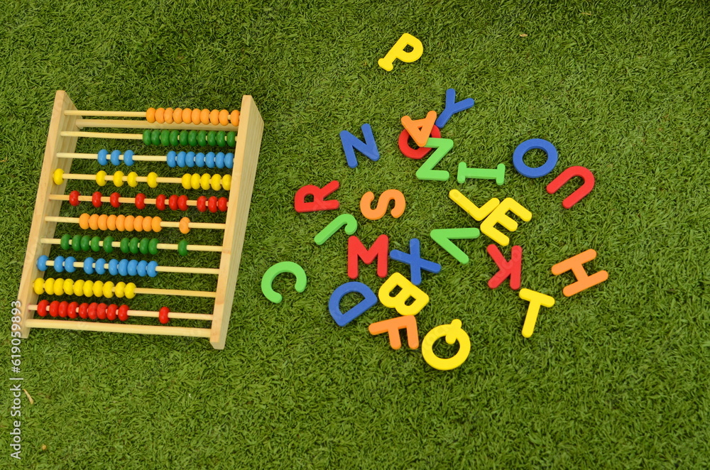 Multi-colored wooden abacus and letters of the English alphabet on a ...