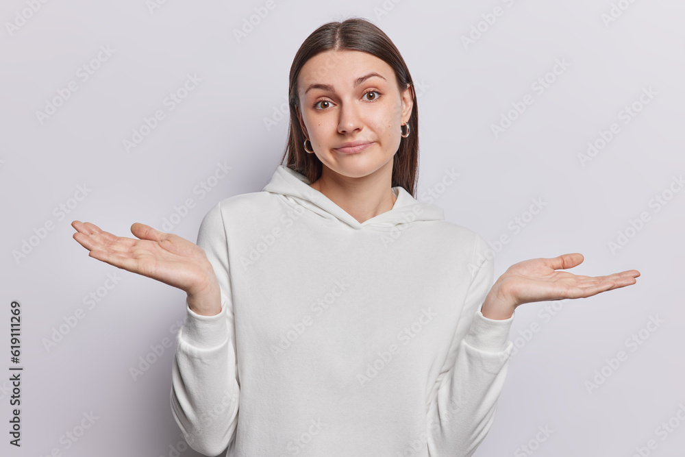 Clueless young dark haired woman has face filled with uncertainty ...