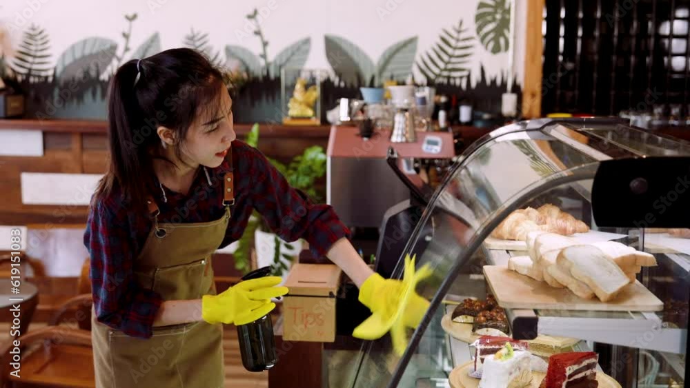 Woman cafe bakery worker's hand wearing latex gloves other hand holding ...