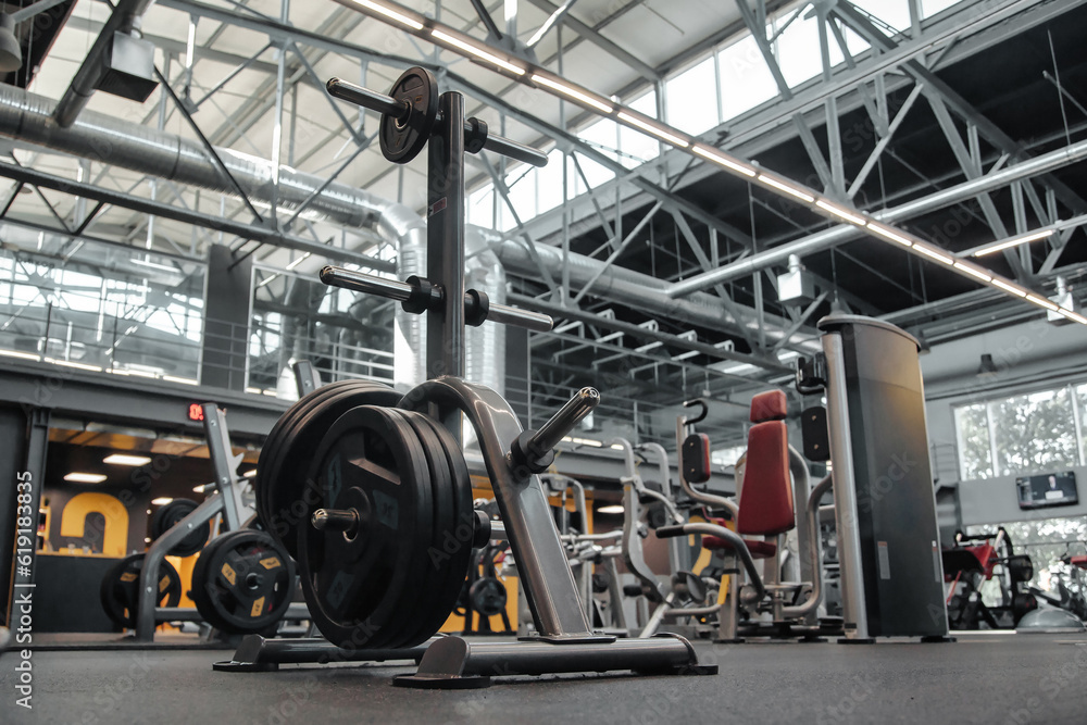New gym interior with sports equipment sport weight rod on rack. Modern ...