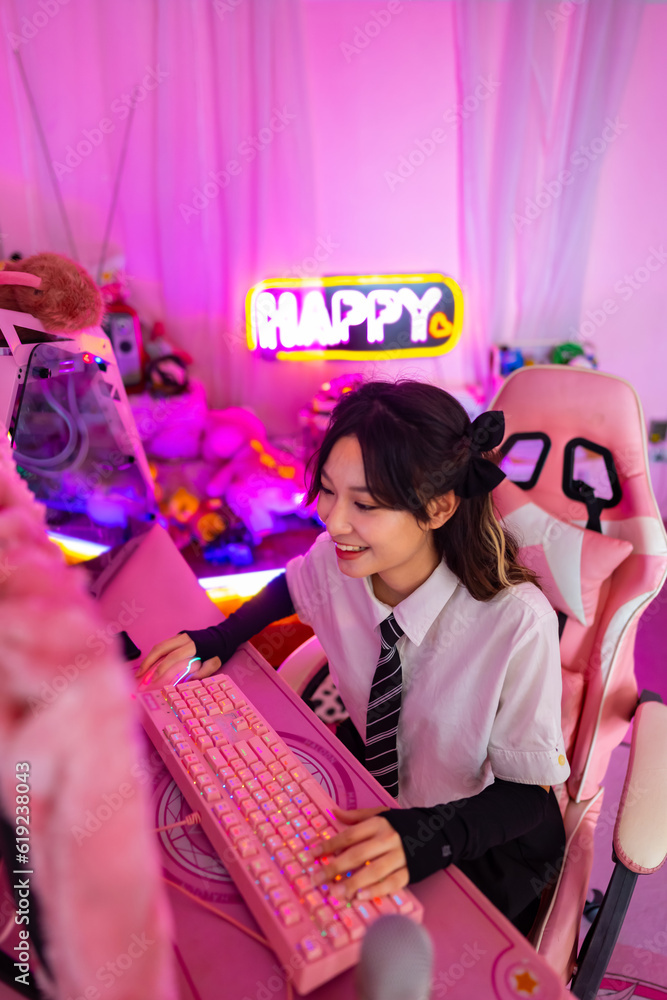 Young Asian woman esport player playing online game on computer in ...