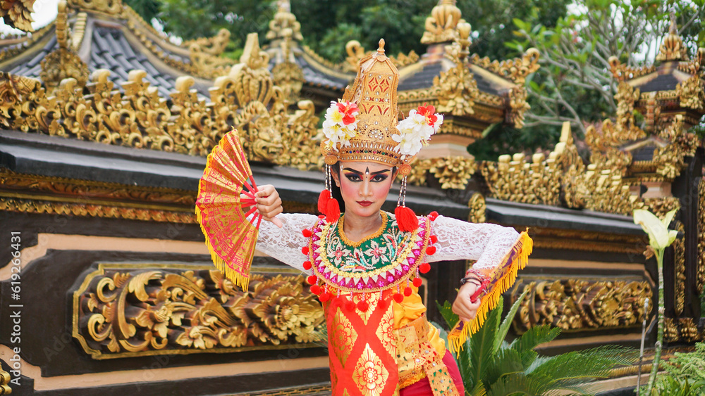 girl wearing Balinese traditional dress with a dancing gesture on ...