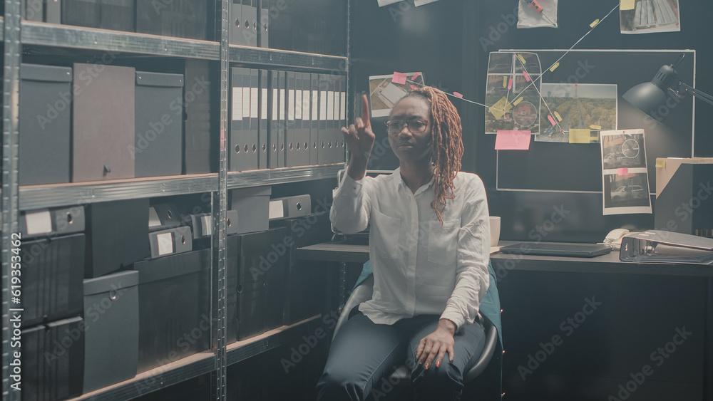 Professional detective examining evidence on hologram, working with ...