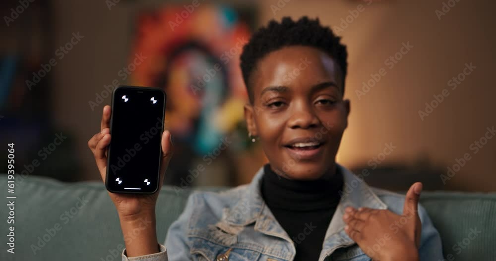 Enthusiastic tech reviewer influencerAfrican woman holds her cellphone ...