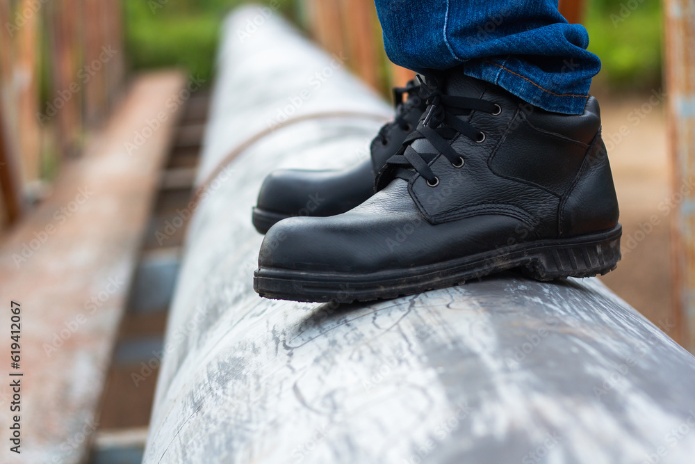 Wear safety shoes to ensure safety at work. construction workers wear ...