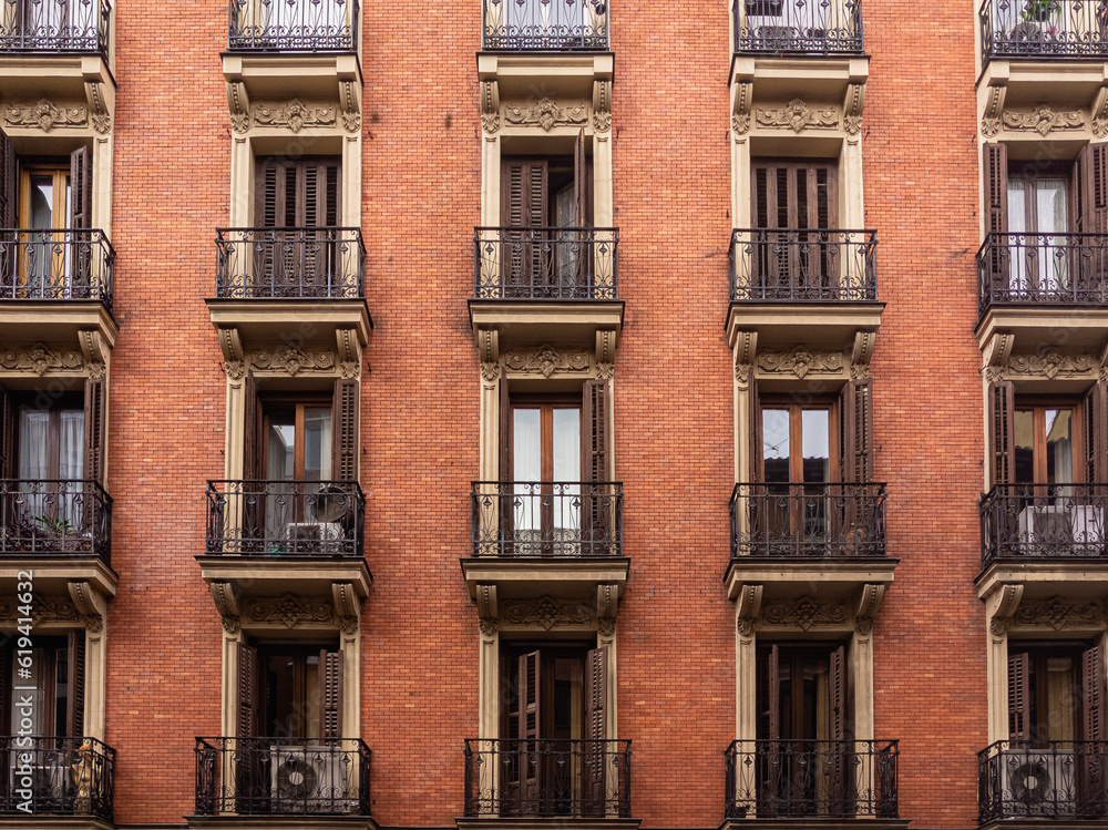 Antique building facade with retro-style window frames and balconies ...