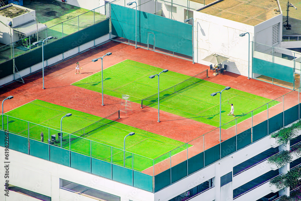 Tennis players competing on a stunning rooftop court, showcasing their ...