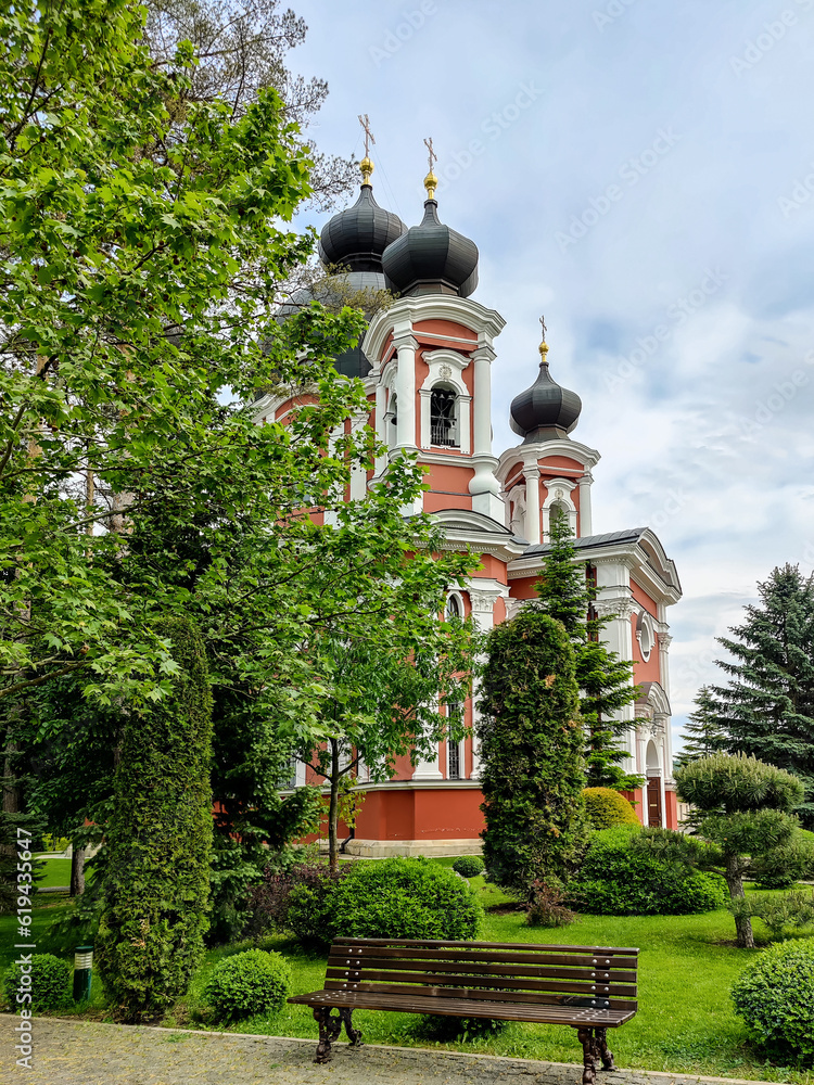 View of Orthodox Cathedral with black domes in monastery against cloudy ...