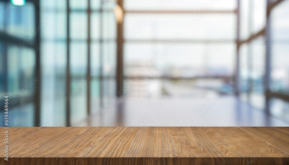 Wood table top on blur glass window wall building background. For ...