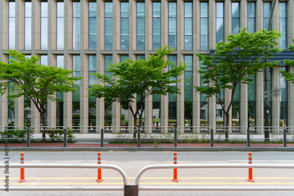 Road side view in front of a building with glass windows. A blocking ...
