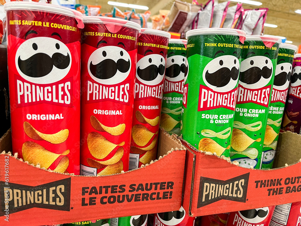 Containers of Pringles Original and Sour Cream & Onion flavours potato ...